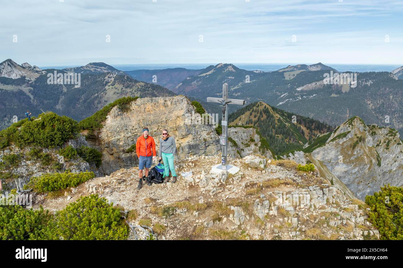 Two hikers on the summit, Austrian Schinder, Tegernsee mountains in the ...
