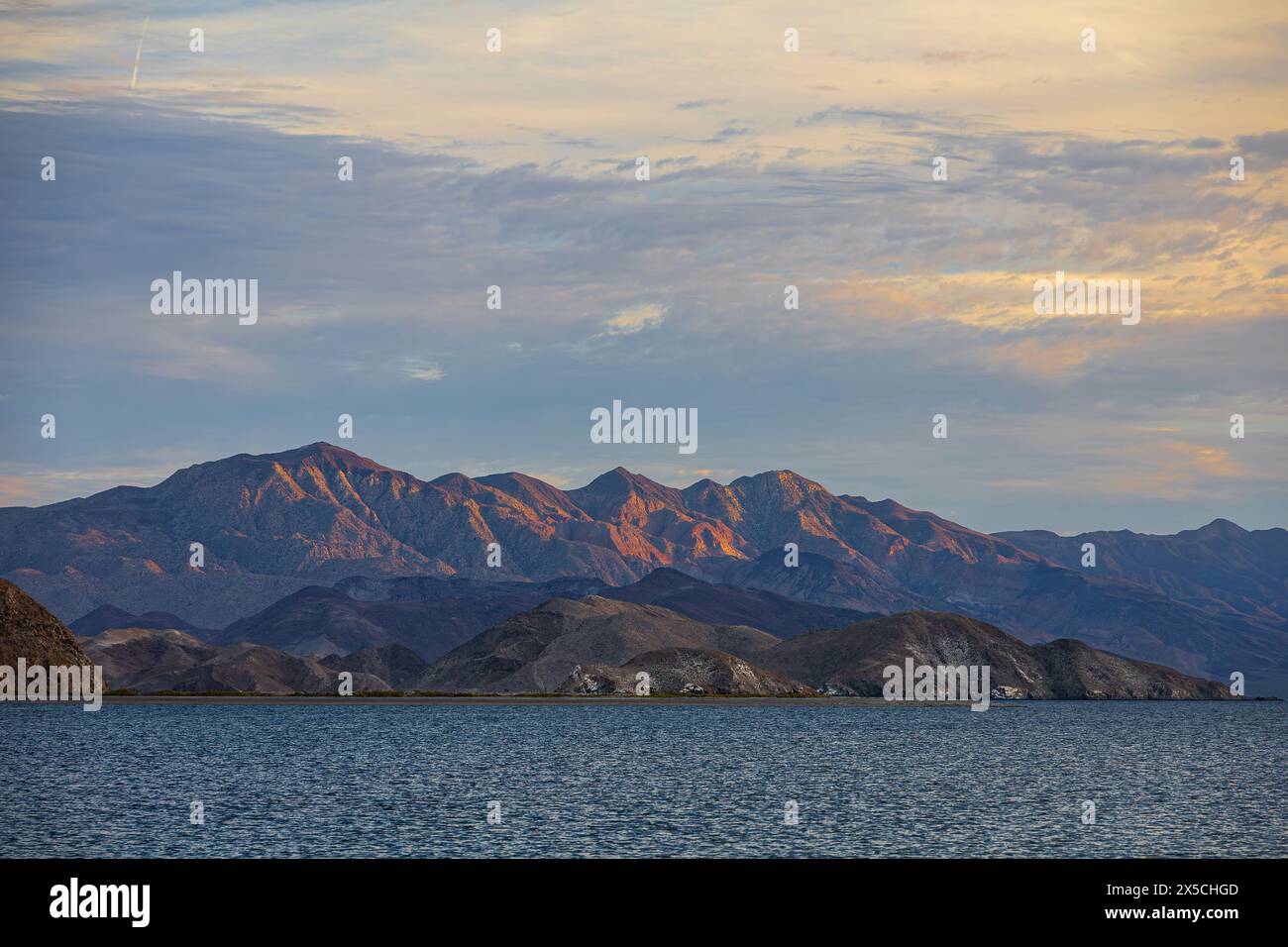 Scenic landscape with rugged arid mountains on the horizon during dusk ...
