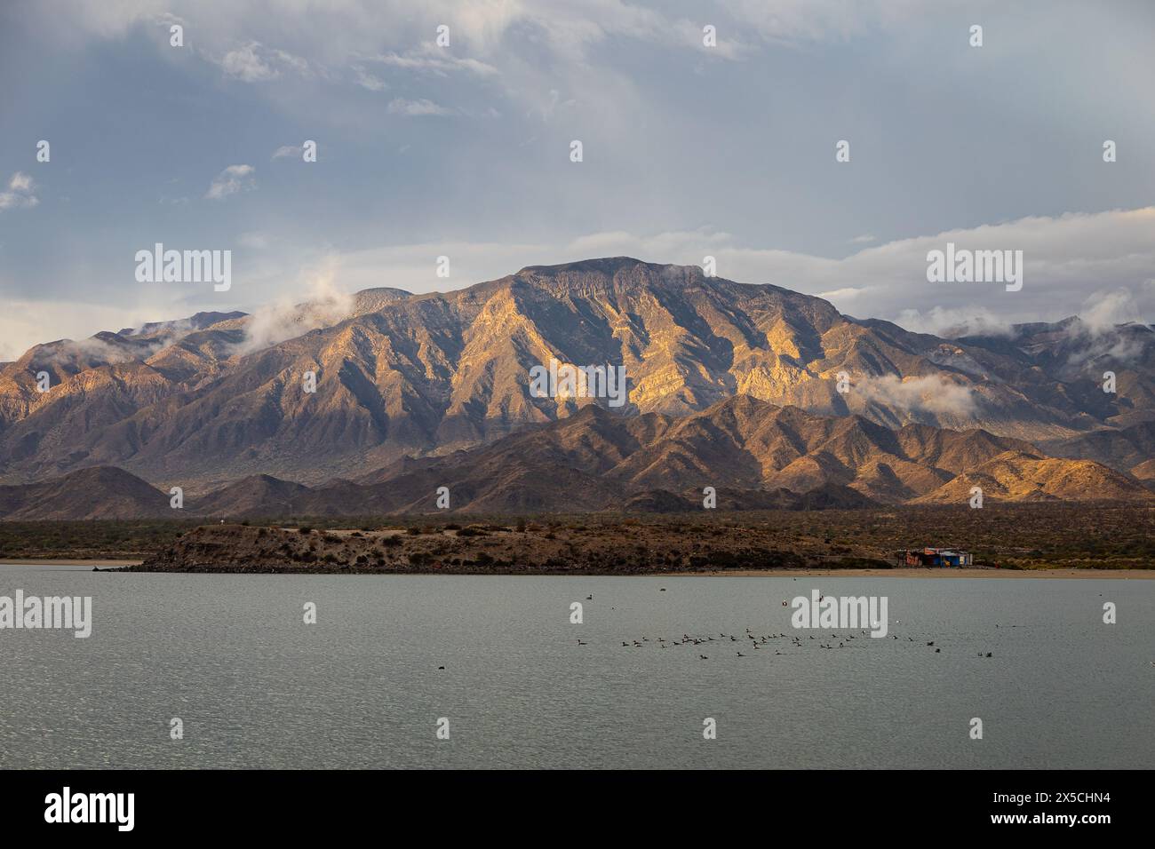 Scenic landscape with rugged arid mountains on the horizon during dusk ...