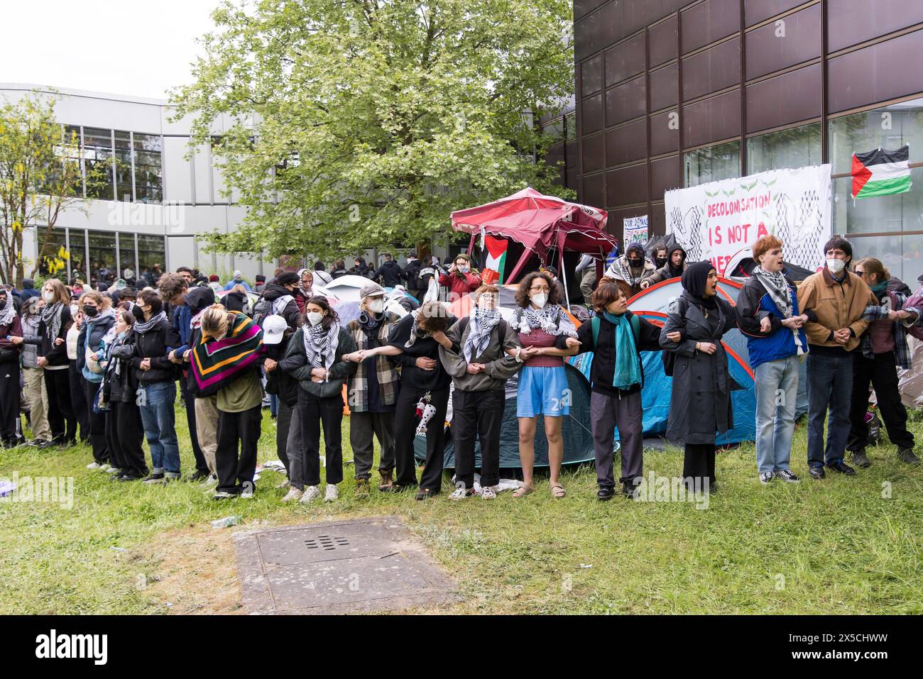 Activists form a human chain in an attempt to protect their tents ...
