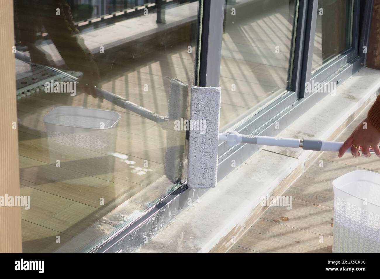 Rubber squeegee cleans a soaped window Stock Photo - Alamy