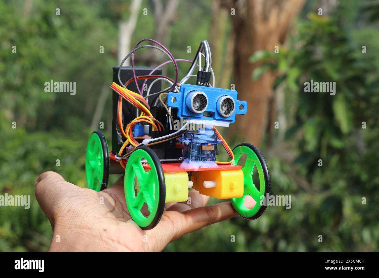 Holding a programmable robotic car that is capable of avoiding ...