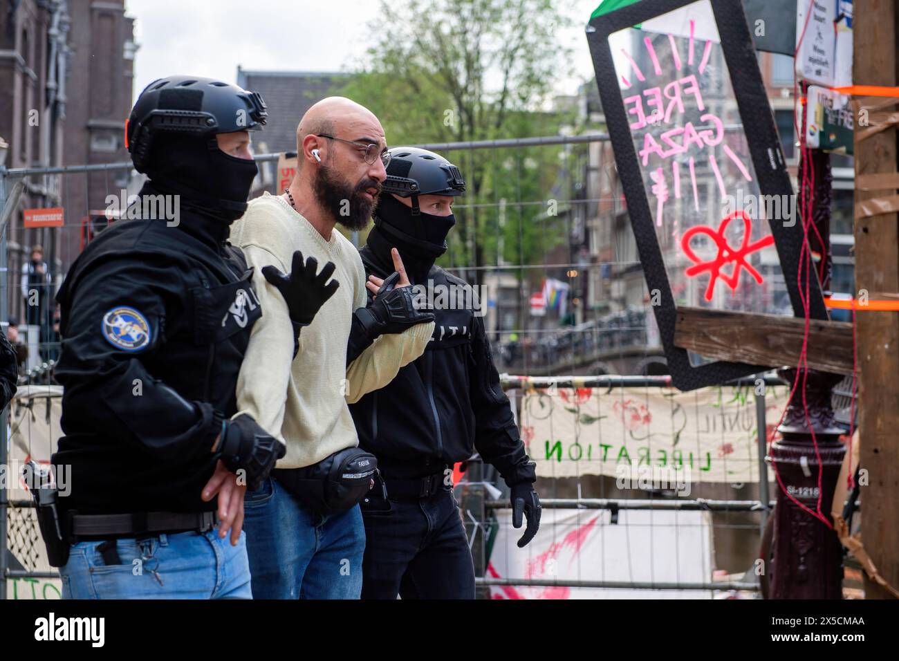 A man is lead away by plain clothed police under arrest after police ...