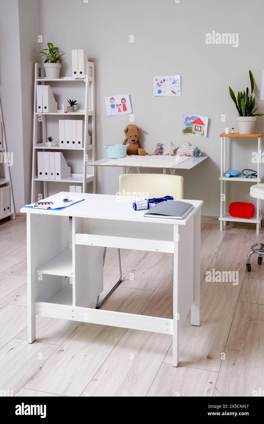 Interior of pediatrician's office with tables and children's drawings ...