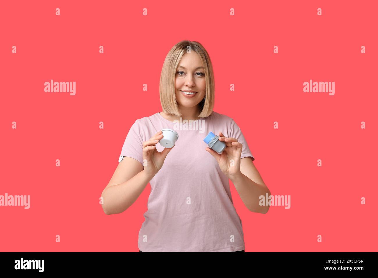 Woman with glucose sensor for measuring blood sugar level and ...