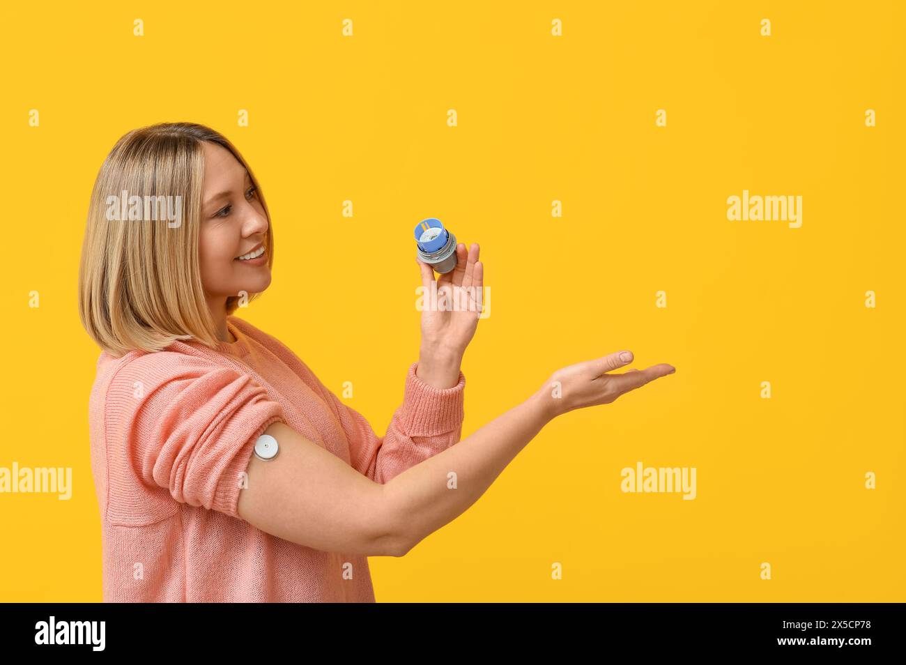 Woman with glucose sensor for measuring blood sugar level and ...