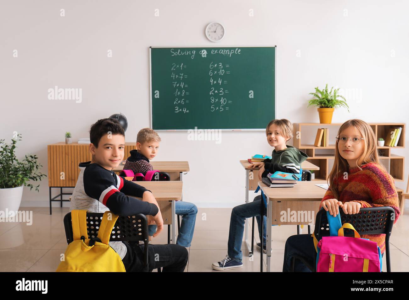 Little pupils having Math lesson at desks in classroom Stock Photo - Alamy