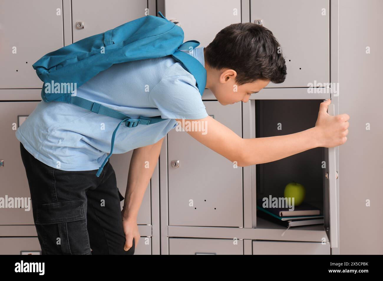 Little boy opening his locker at school Stock Photo - Alamy