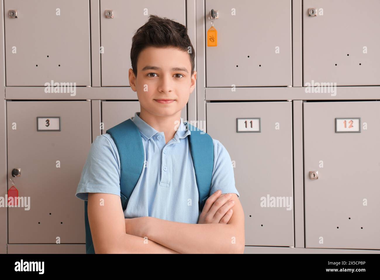 Little boy near locker at school Stock Photo - Alamy