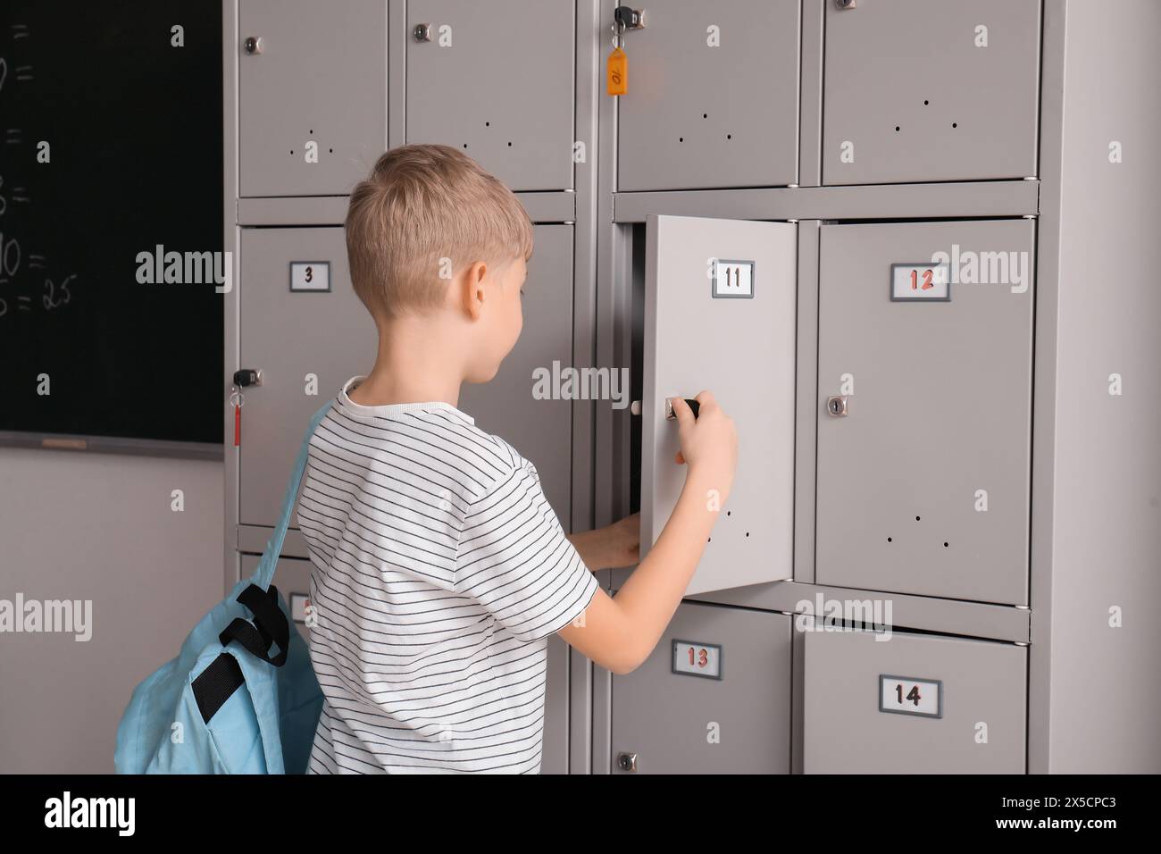 Cute little boy opening his locker at school Stock Photo - Alamy
