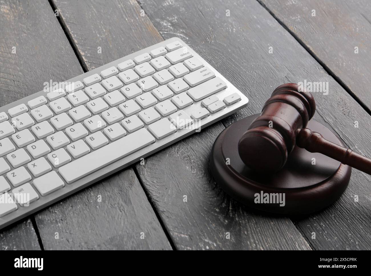 Modern keyboard and judge's gavel on dark wooden background, closeup Stock Photo - Alamy