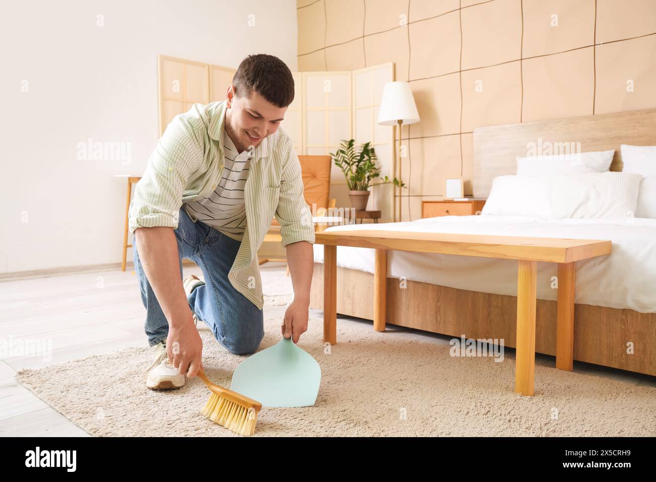 Happy smiling young man sweeping hi-res stock photography and images ...