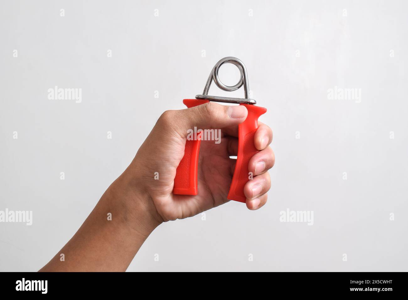 Finger-Hand exerciser has handgrip for exercise isolated on white ...