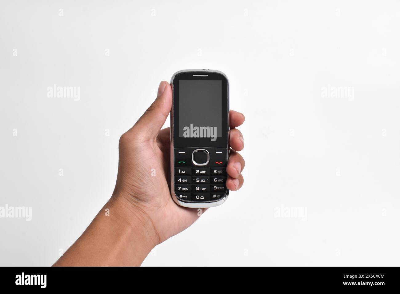 Hand holding Old Mobile Phone isolated on white background. Old ...
