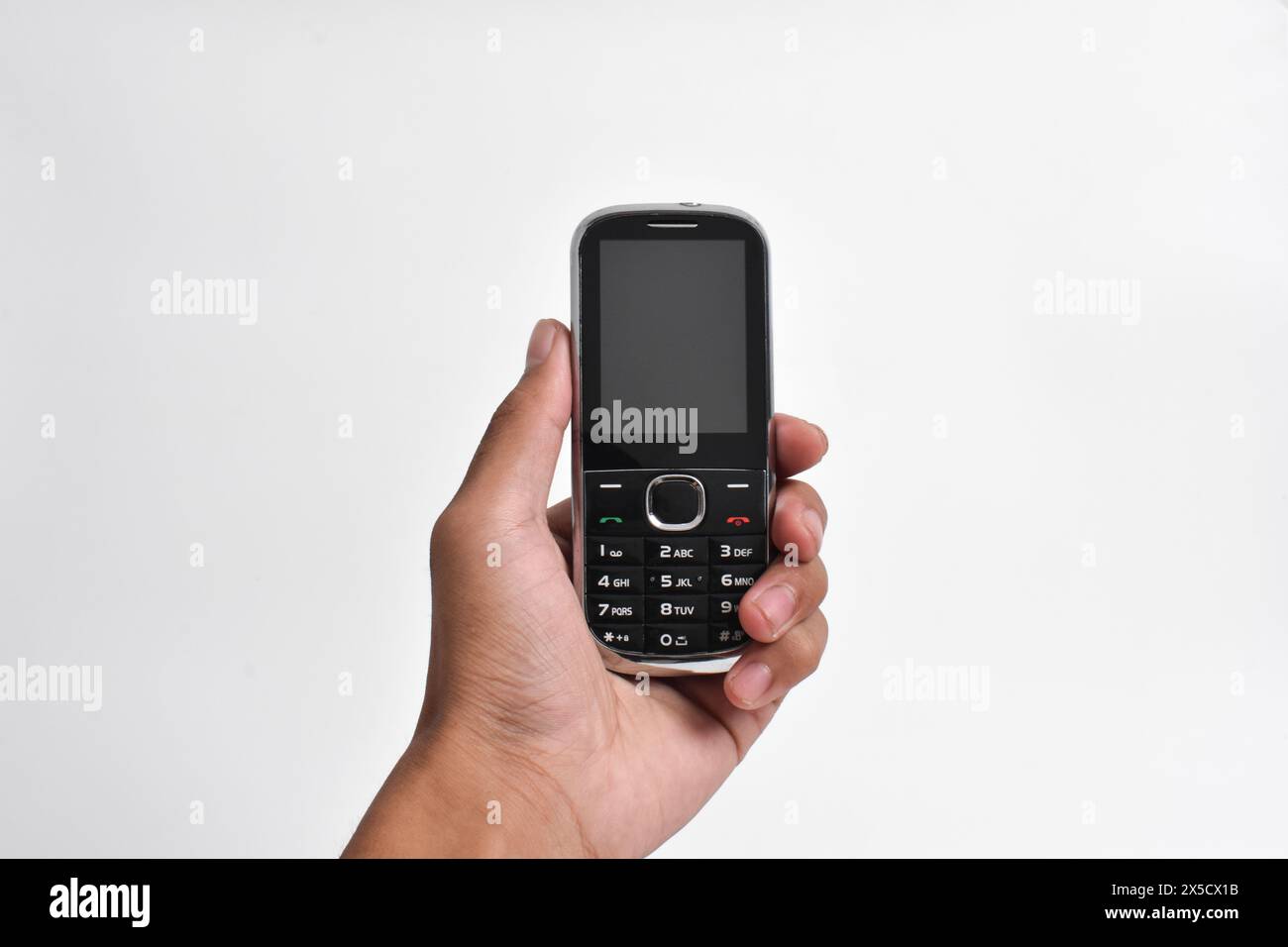 Hand holding Old Mobile Phone isolated on white background. Old ...