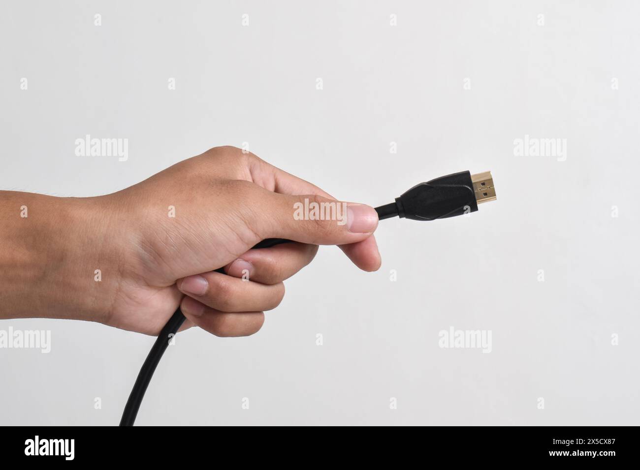 Hand holding HDMI cable connector on white background Stock Photo - Alamy