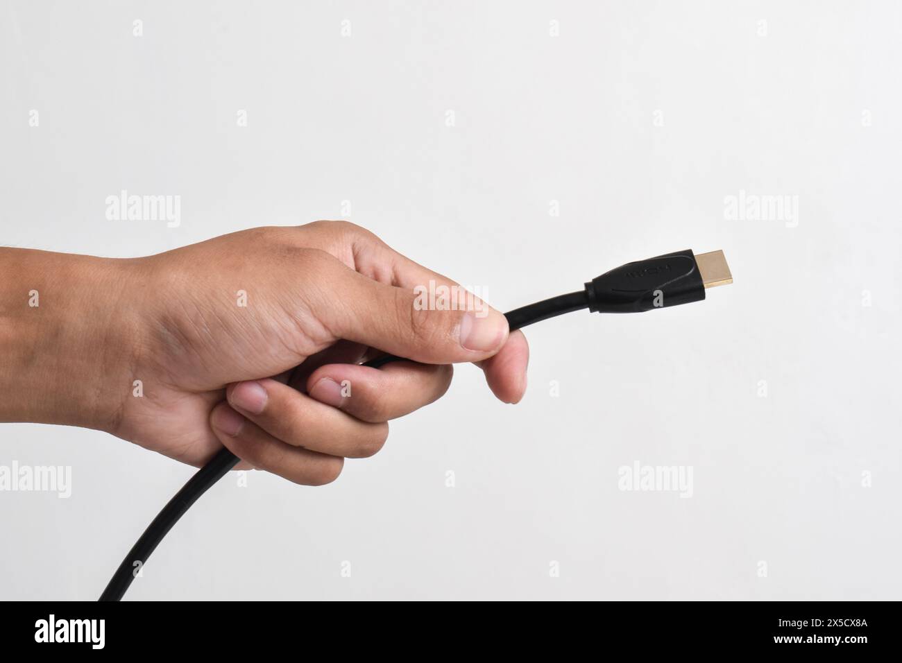 Hand holding HDMI cable connector on white background Stock Photo - Alamy