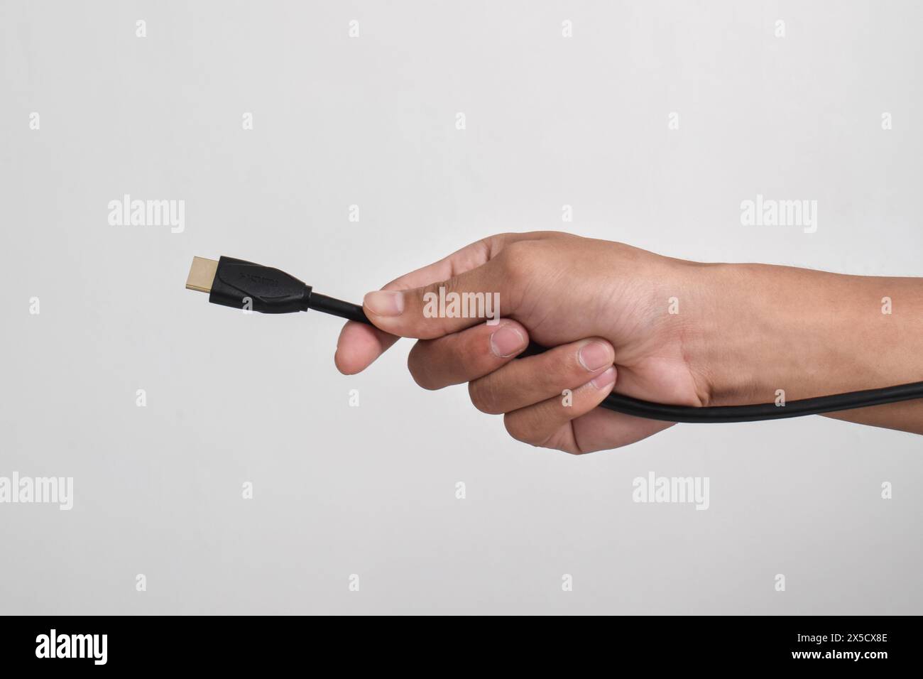 Hand holding HDMI cable connector on white background Stock Photo - Alamy