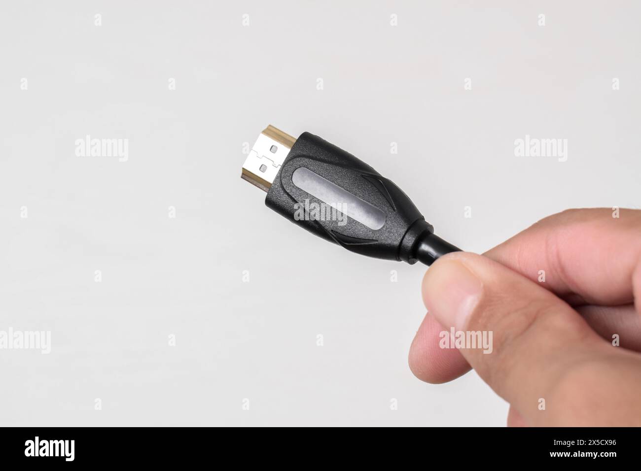 Hand holding HDMI cable connector on white background Stock Photo - Alamy