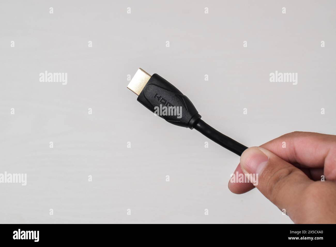 Hand holding HDMI cable connector on white background Stock Photo - Alamy