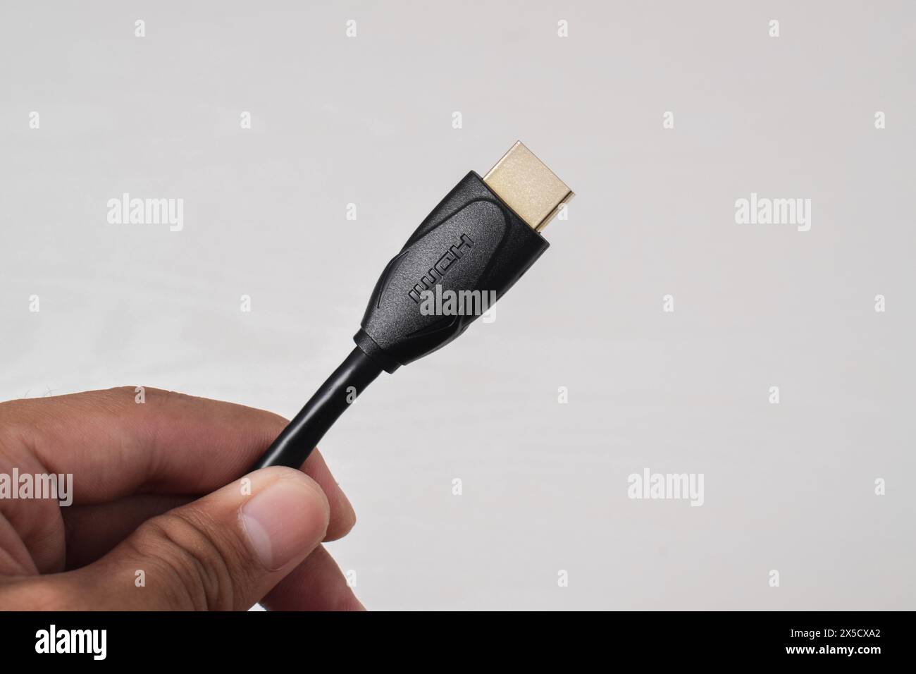 Hand holding HDMI cable connector on white background Stock Photo - Alamy