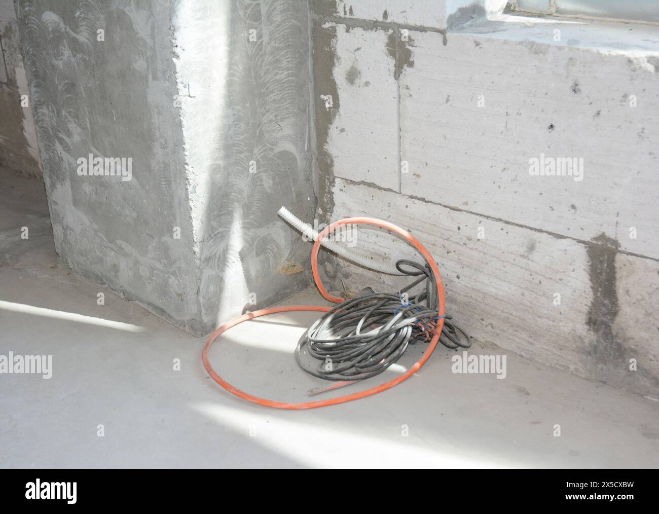 Close up on electric wire in concrete wall in house construction site ...
