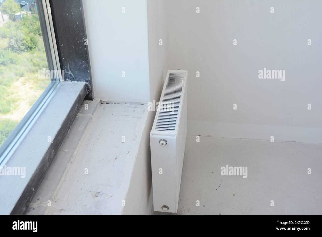 Top view on house metal radiator heating and unfinished window sill ...