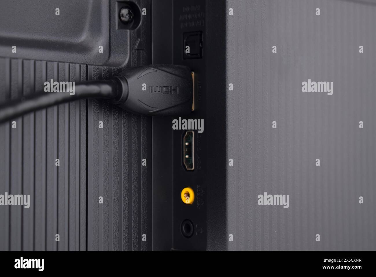 Protected hdmi cable connected to the monitor. The HDMI cable is ...