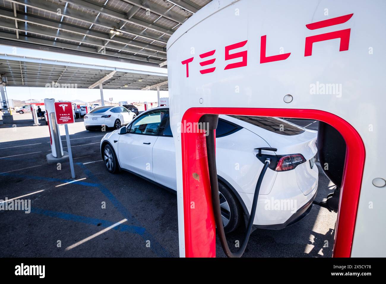 A large collection of Tesla Superchargers in action along Interstate 15 ...