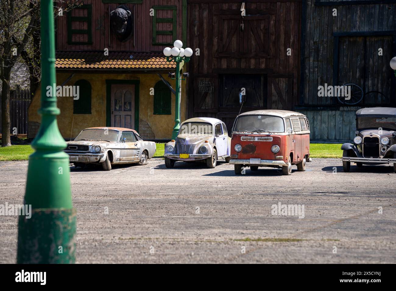 Vintage cars parked in front of colorful buildings in a rustic setting Stock Photo - Alamy