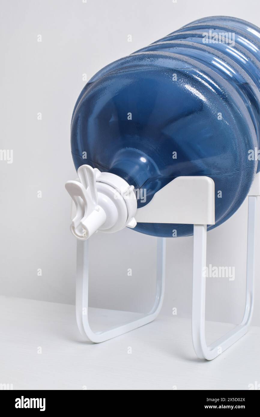 Plastic gallon on a standing shelf with a faucet isolated on white ...