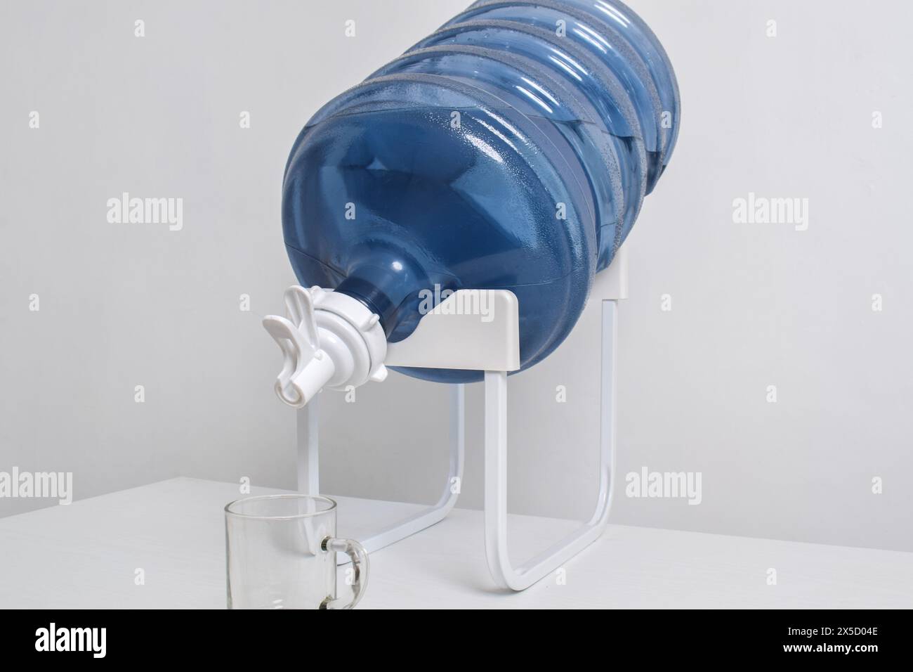 Plastic gallon on a standing shelf with a faucet isolated on white ...