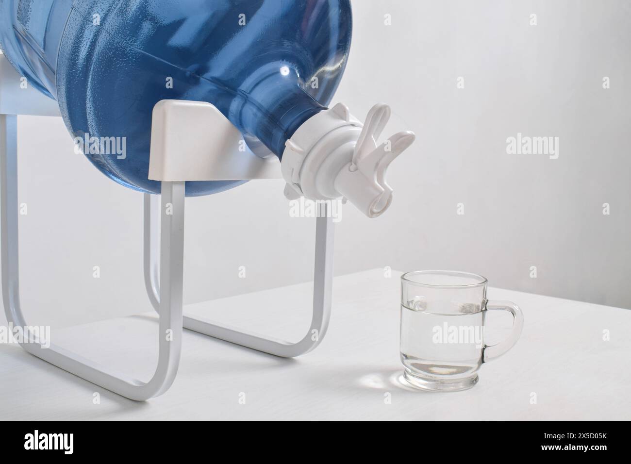 Plastic gallon on a standing shelf with a faucet isolated on white ...