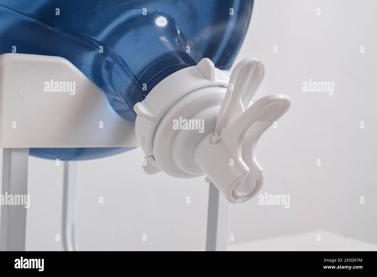 Plastic gallon on a standing shelf with a faucet isolated on white ...