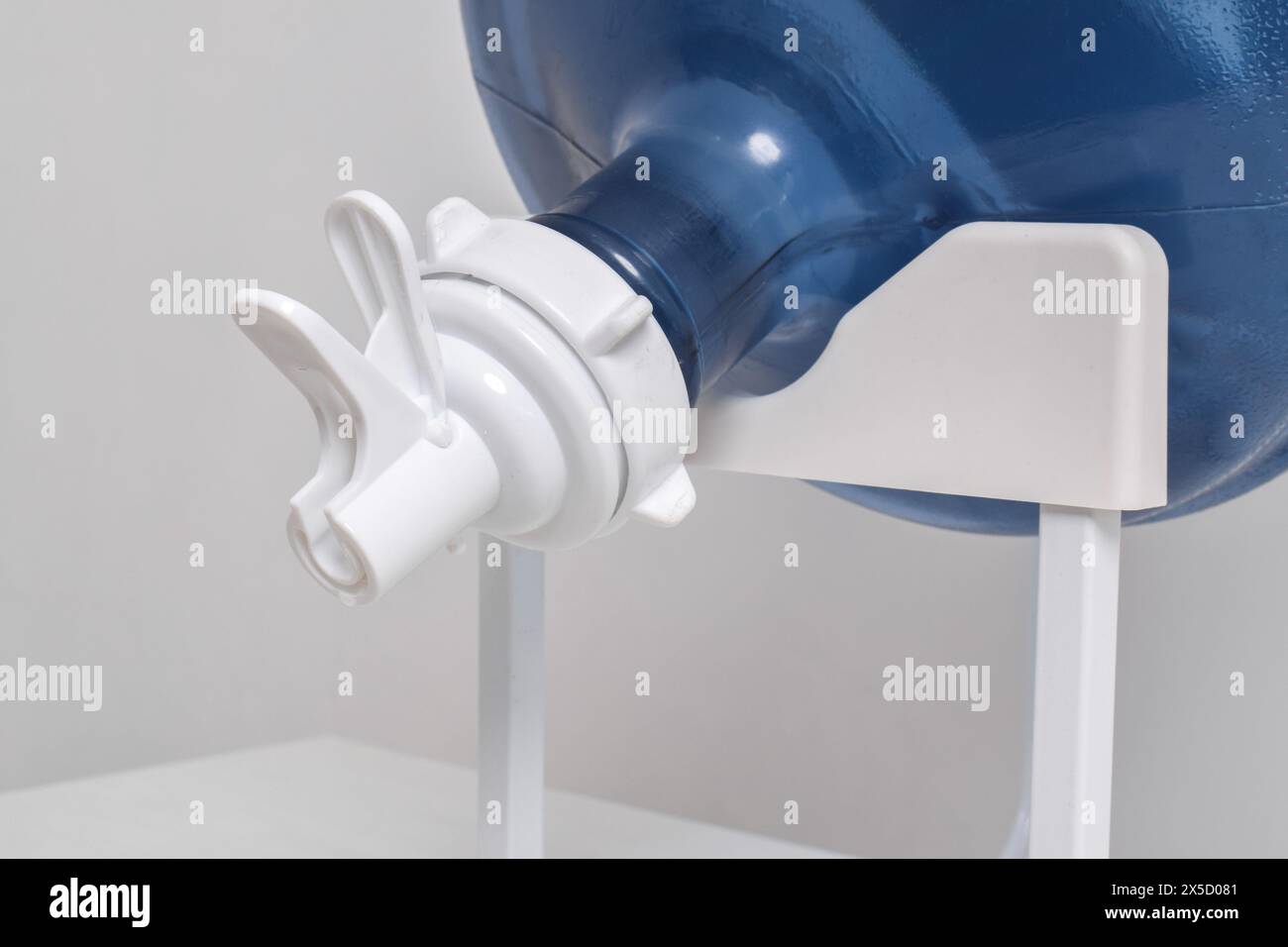 Plastic gallon on a standing shelf with a faucet isolated on white ...