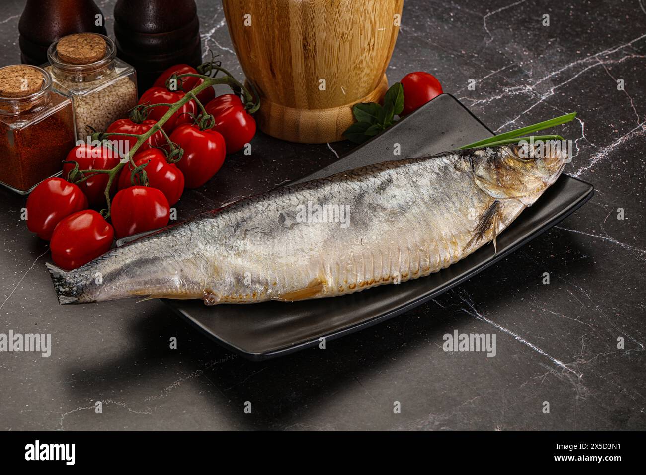 Whole raw salted herring fish in the plate Stock Photo - Alamy