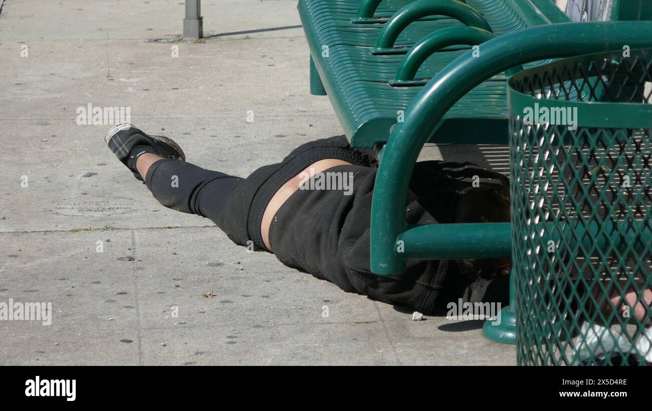 Los Angeles, California, USA 8th May 2024 Homeless man sleeping at bus ...
