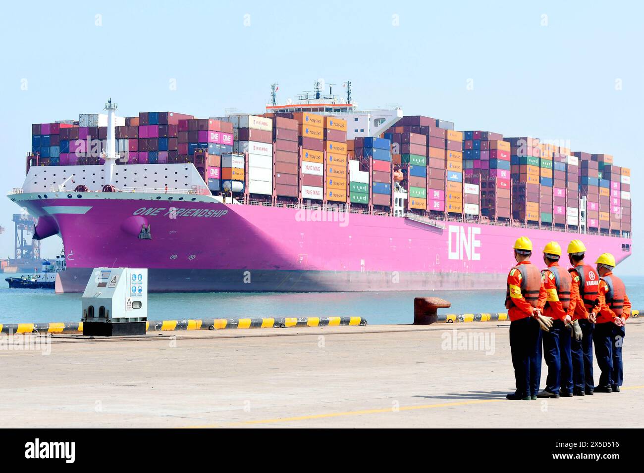 QINGDAO, CHINA - MAY 9, 2024 - Dockworkers wait for a cargo ship to ...