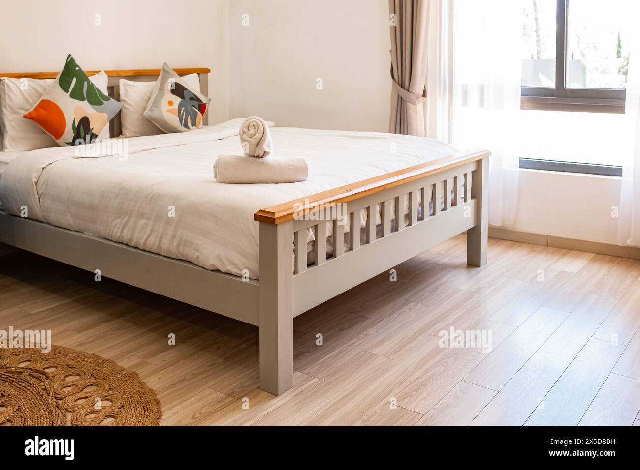 Nice bed in bedroom. Stylish room interior with big comfortable bed ...