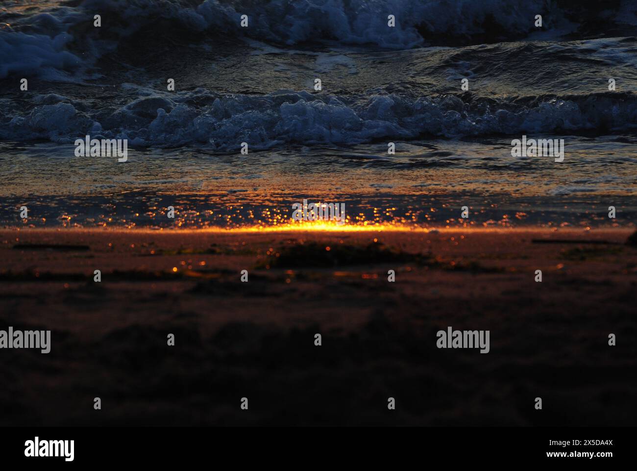 Mesmerizing waves blending into the sky Stock Photo - Alamy