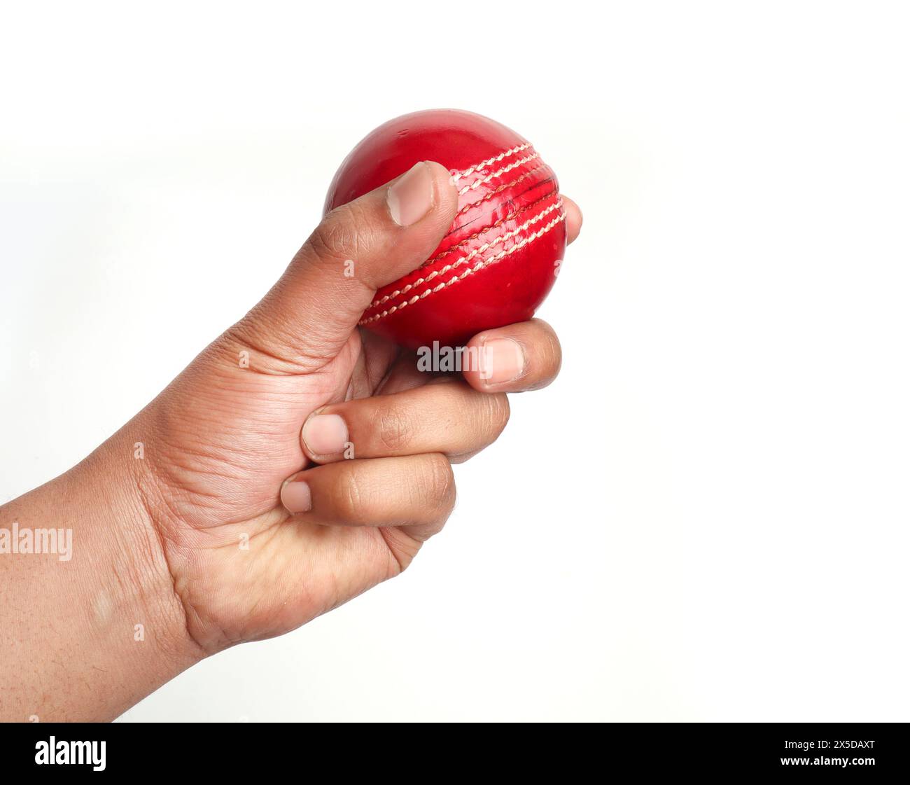 red cricket leather ball in bowler hand on the white background Stock ...