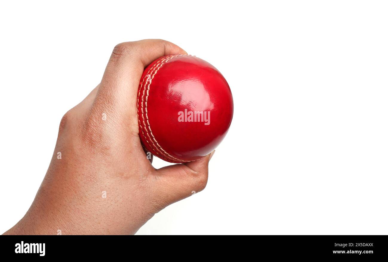 red cricket leather ball in bowler hand on the white background Stock ...