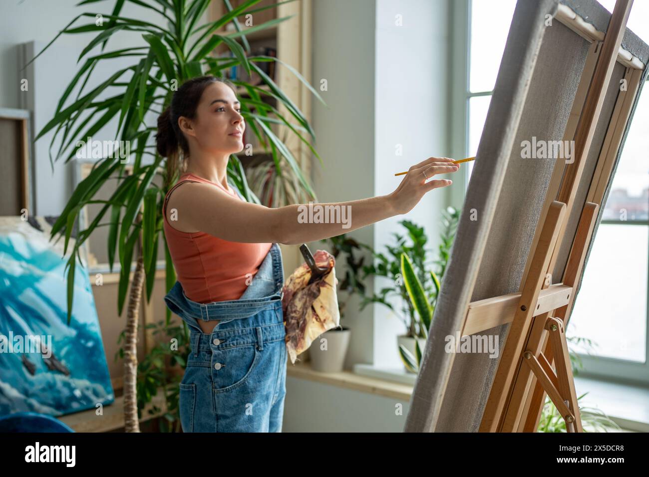 Positive optimistic woman painter embodies creative ideas expresses ...