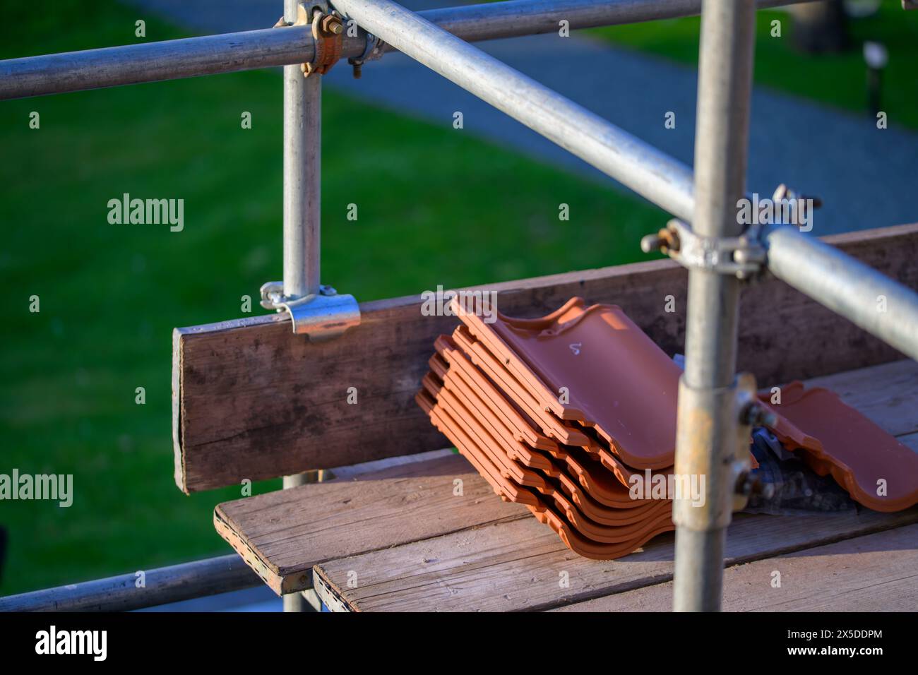 Red Clay single roll pan roof tiles laid out ready to be fitted on the ...