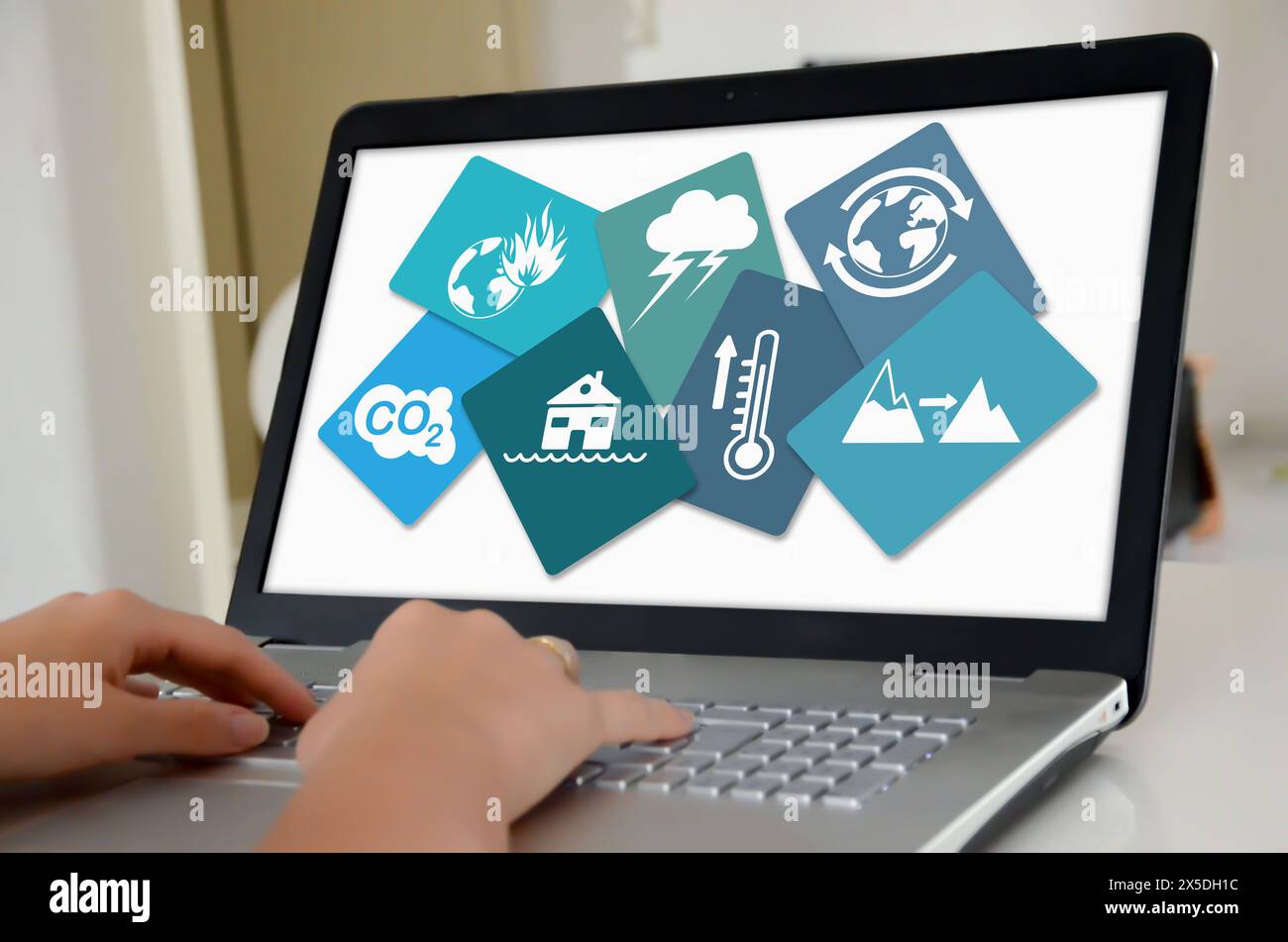 Hands on a laptop with screen showing climate change concept Stock ...