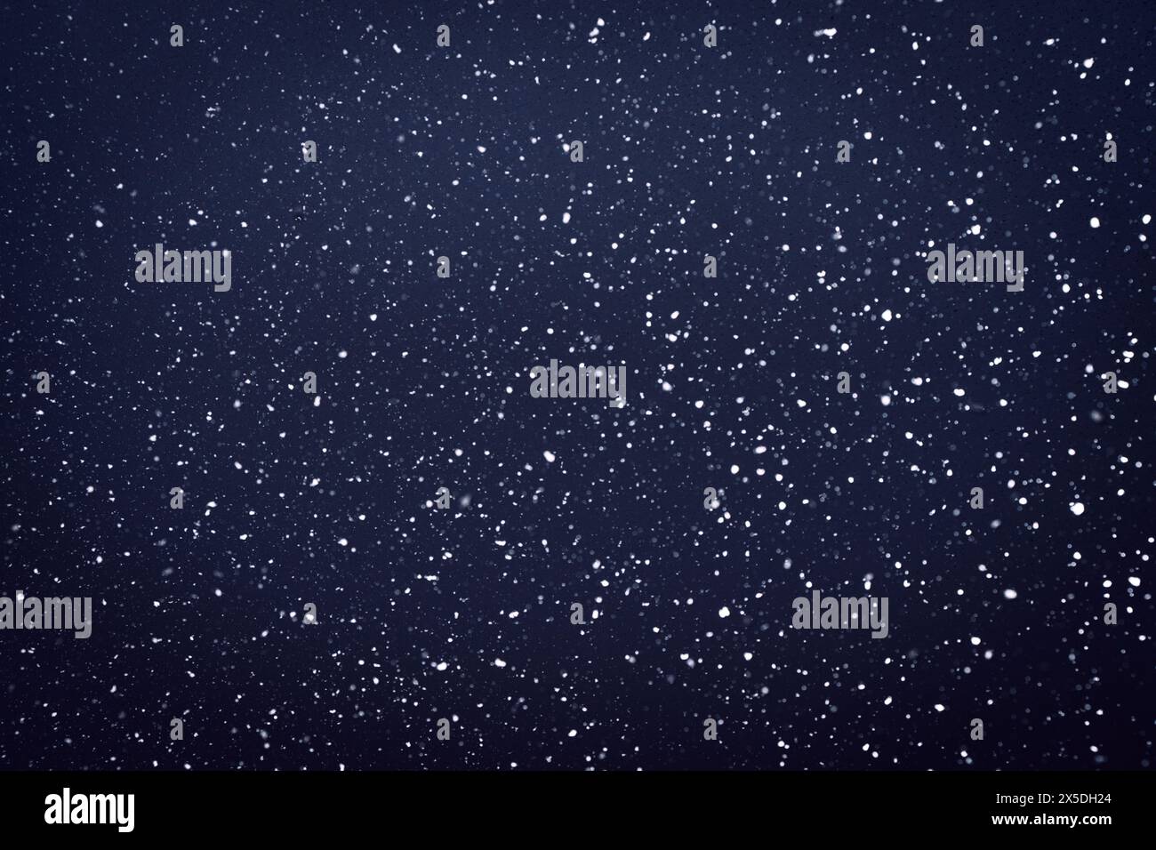 Natural snow particles in the air. Dark blue fading to black background ...