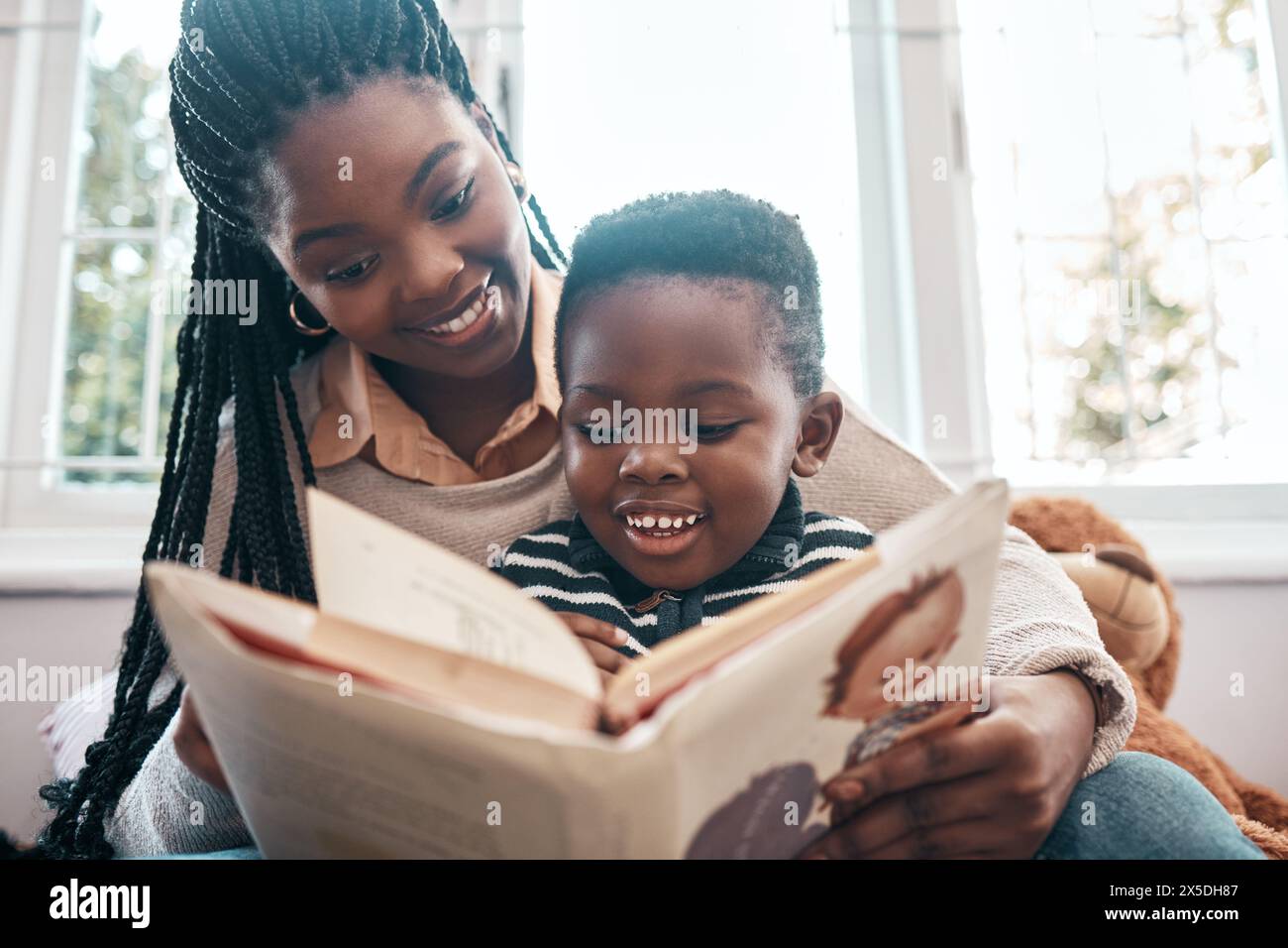 African woman, child and book for learning, education and reading on ...