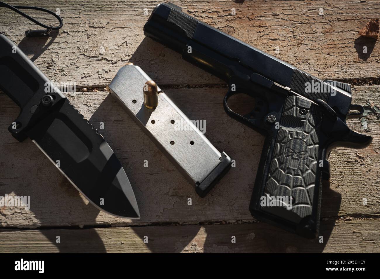 American M1911 pistol and a large folding knife, close-up photo Stock ...