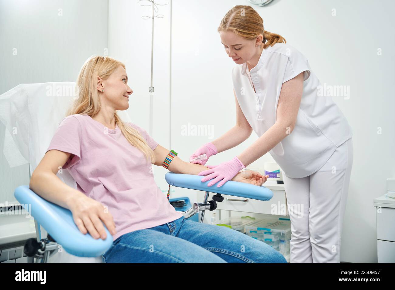 High-qualified nurse going to take the blood sample with vacutainer ...
