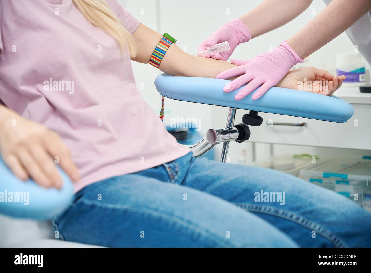 Close-up nurse looking for vein in patient hand using special ...